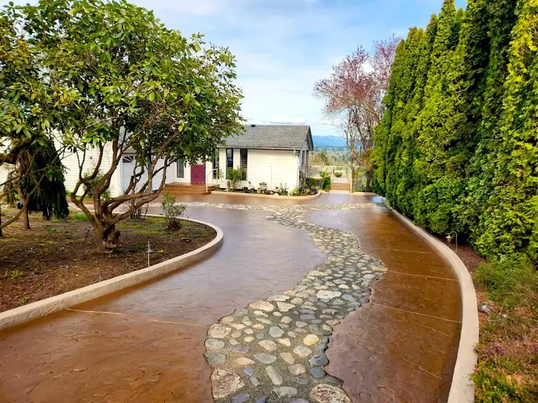 Stamped Concrete Driveway with Meandering Inset River Stone Feature in ...