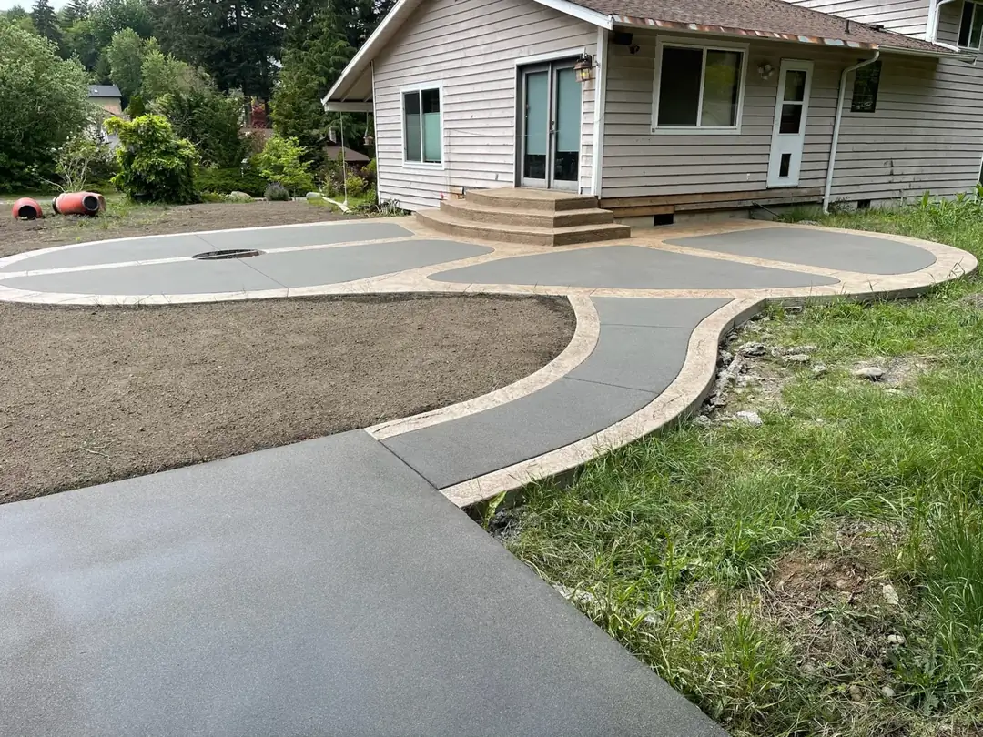 Two-Tone Concrete Patio with Stamped Borders and Curved Steps in ...
